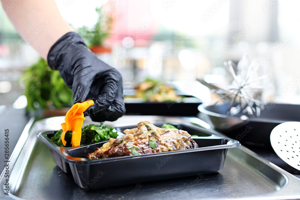Catering. Meal prep.The cook prepares take-out dishes. Stock Photo ...