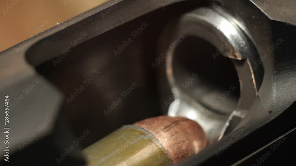 Weapon.Preparation of weapons for shooting. Close-up bullet.Bullet in ...