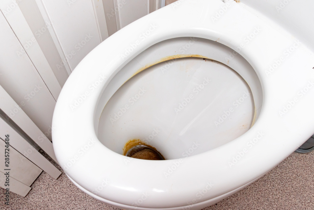 Dirty unhygienic toilet bowl with limescale stain at public restroom ...