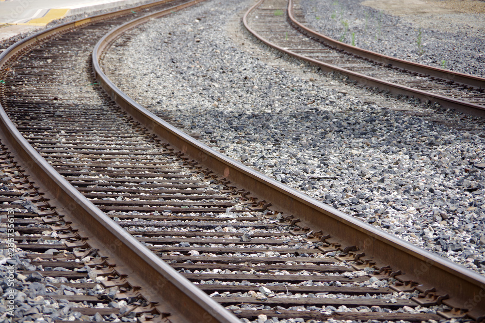 Close view on a section of the tracks of a curve in railroad line with ...