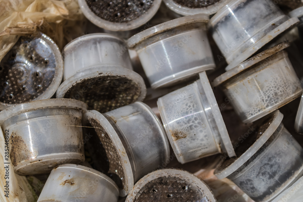 Closeup of used coffee capsules, recycle of plastic single-serve coffee ...