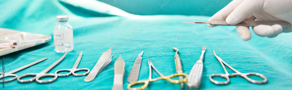 Hand holding surgical knife instruments and operating room,banner size ...