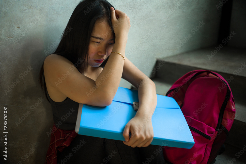 Dramatic portrait of Asian female college student bullied. Young ...