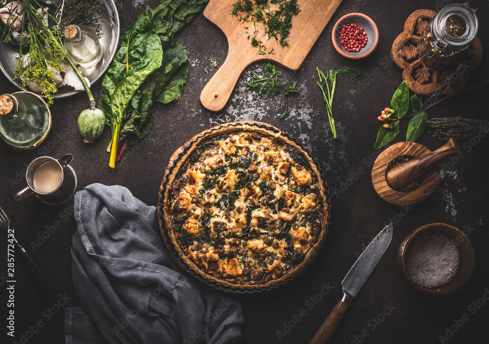 Homemade tasty salmon open faced pie or quiche lorraine on dark rustic ...