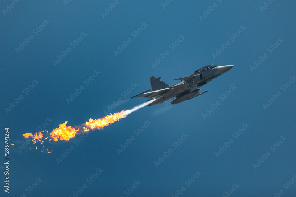 Jet fighter in the sky with fire flame Stock Photo | Adobe Stock