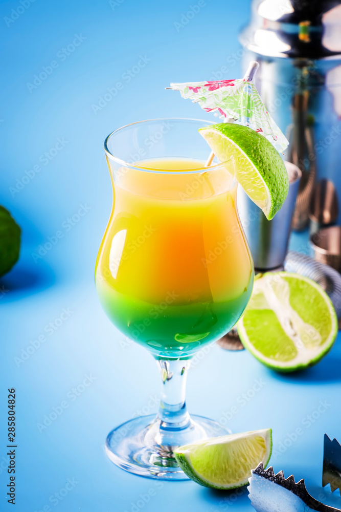 Double layer green yellow alcoholic cocktail with mango juice, rum ...