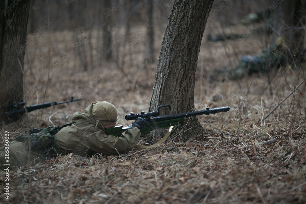Active military exercises in the forest. Shootout army in the autumn ...