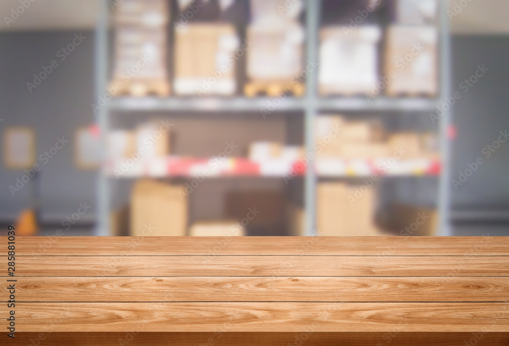 Wood table in warehouse storage blur background with empty copy space ...