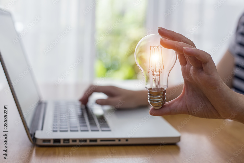 women hand holding light bulb. idea concept with innovation and ...