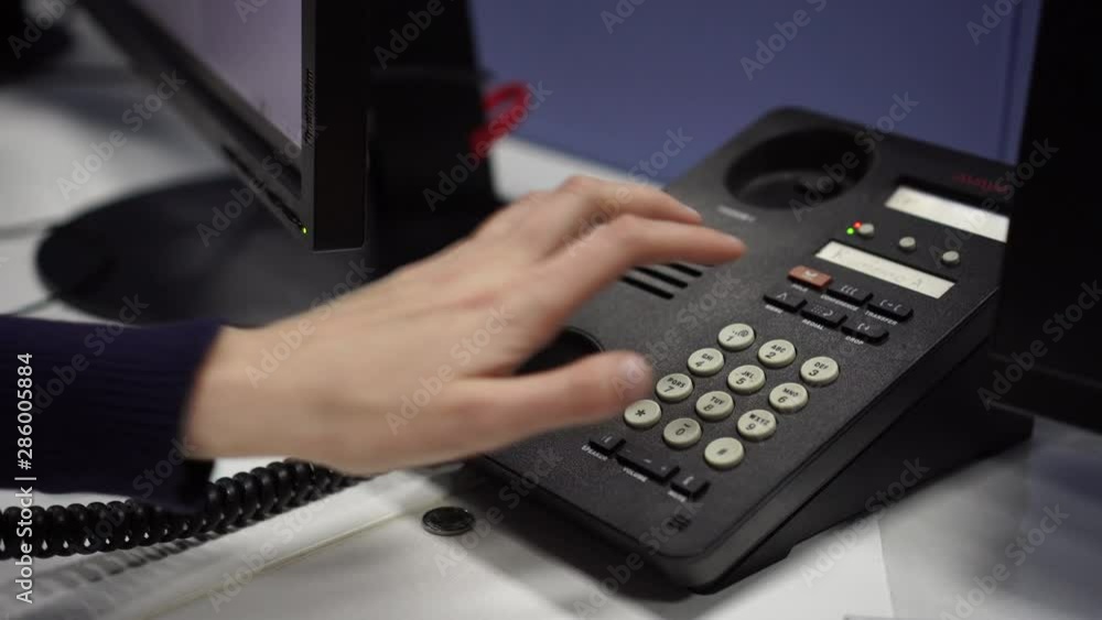 A Close-up Shot of Office Worker Making a Call on the Office Phone ...
