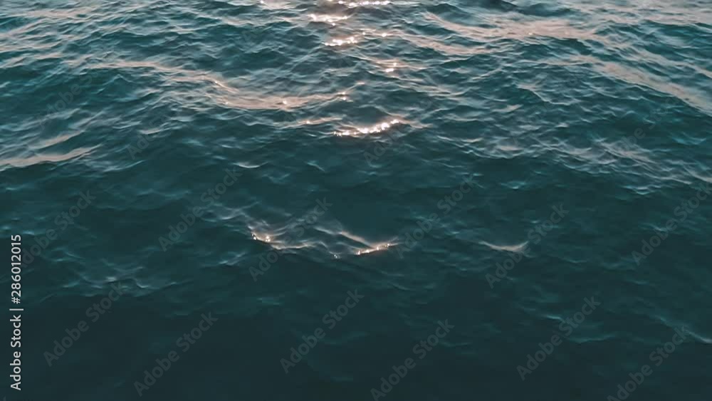 4K aerial top down view from high altitude of green sea water texture ...