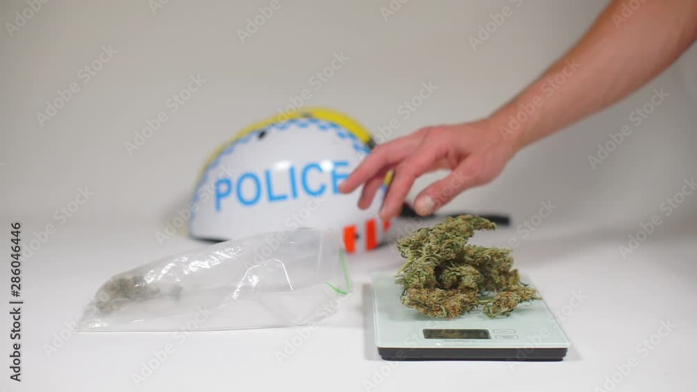 weed lies on the scales opposite the inscription police Stock Video ...