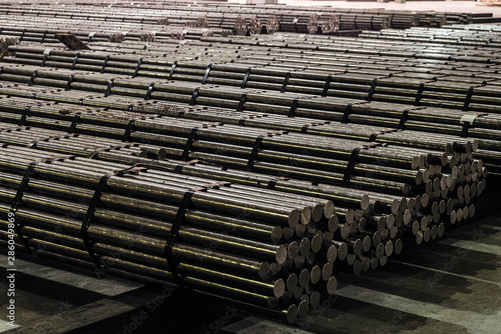 Round steel section rolling profile in stacked. Warehouse of metal ...