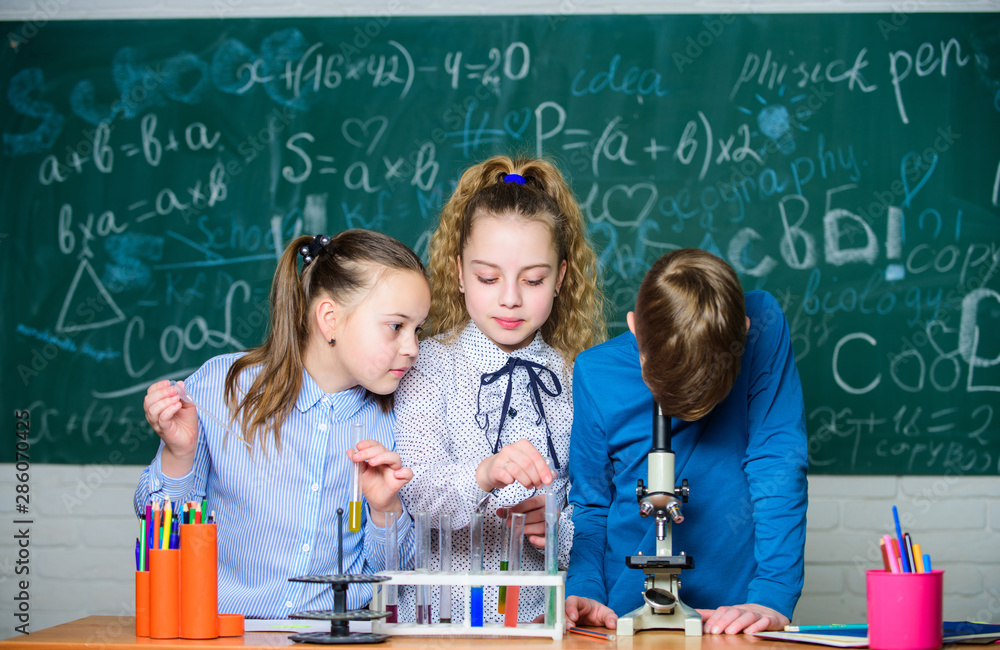 students doing biology experiments with microscope. Little kids ...