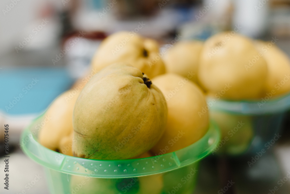 Quince fruits are in a plastic container. Cooking quince fruit. Stock ...