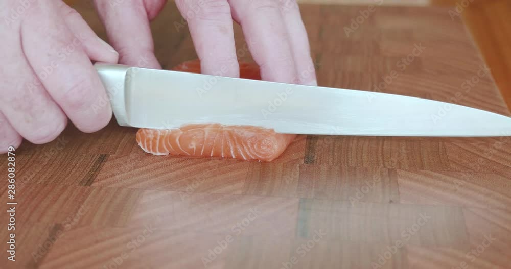 Video Stock Sushi chef picks up a knife and cuts thin slices of fatty ...