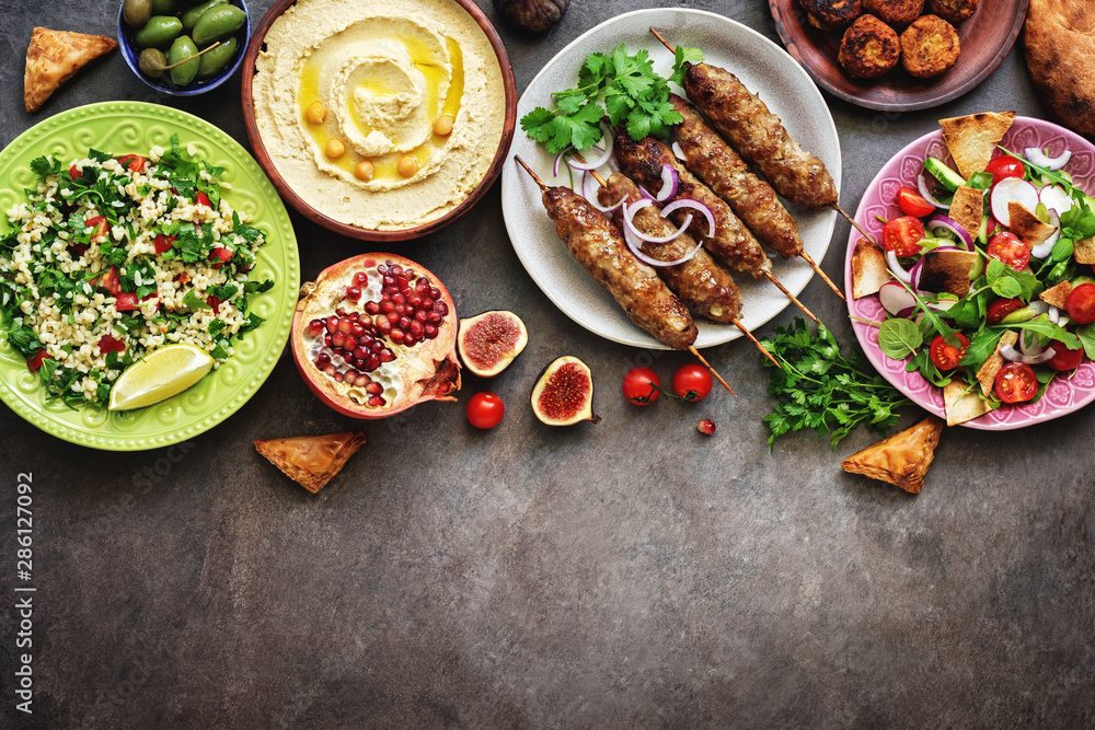 Assorted Middle Eastern and arabic dishes on a dark rustic background ...
