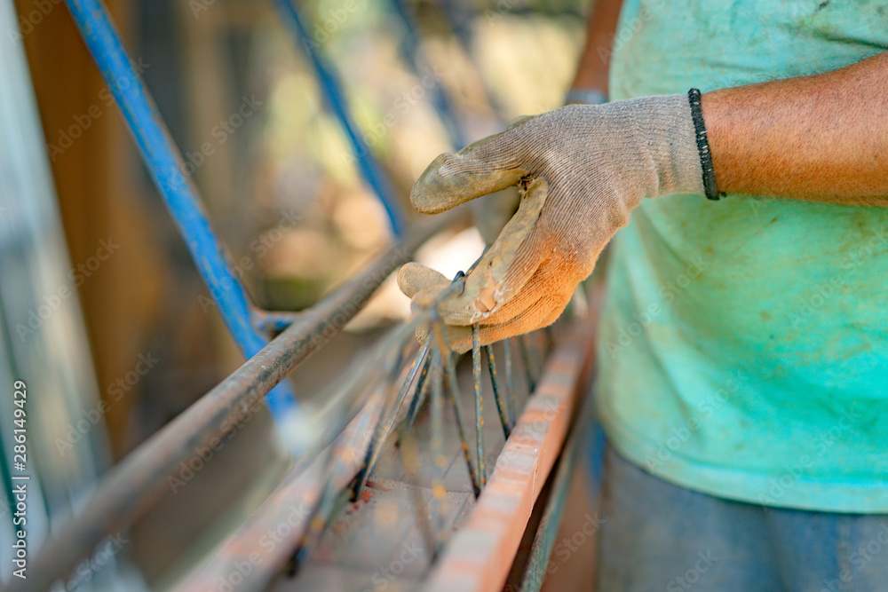 Construction worker holding carry lattice girder and truss girders ...