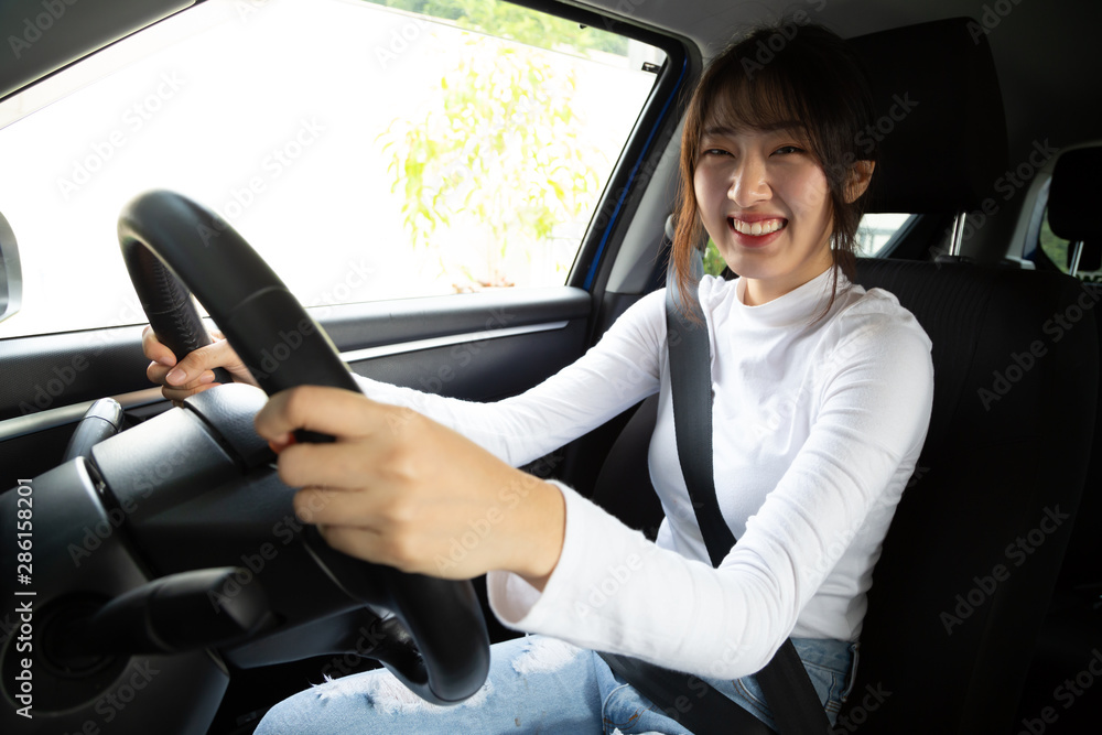Asian women driving a car and smile happily with glad positive ...