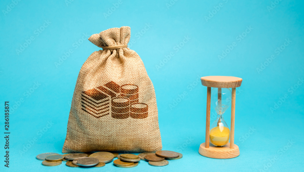 Money bag with coins and a clock / hourglass. Time management and ...