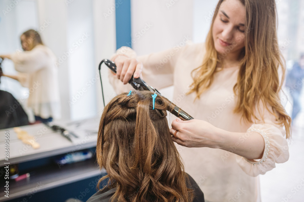 beauty, hairstyle concept, happy young woman and hairdresser with hair ...
