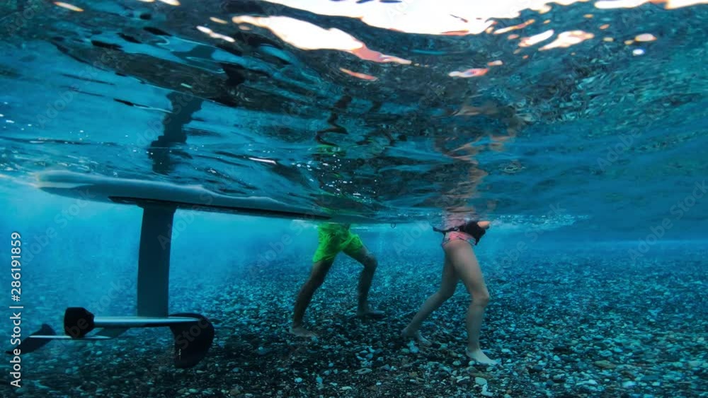 Surfer female at the sea on surfboard. Beautiful underwater view of ...