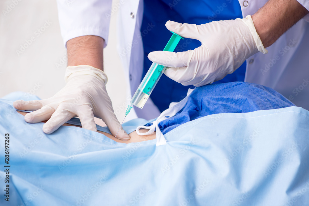 Female patient getting an injection in the clinic Stock Photo | Adobe Stock