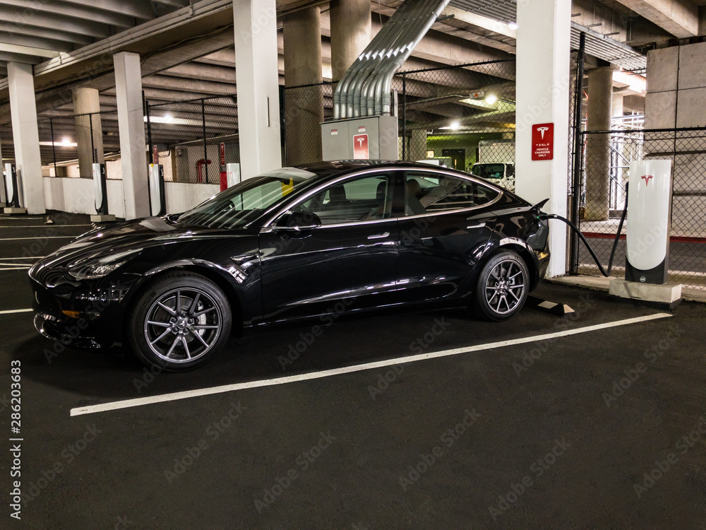 Black Tesla Model 3 Supercharging Plugged In Charged Stock Photo ...