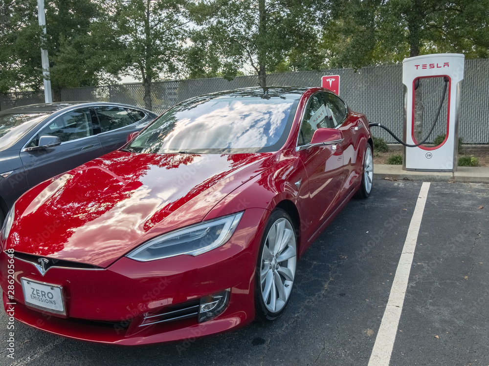 Tesla Red Model S Supercharging Electric Car Plugged In Stock Photo ...
