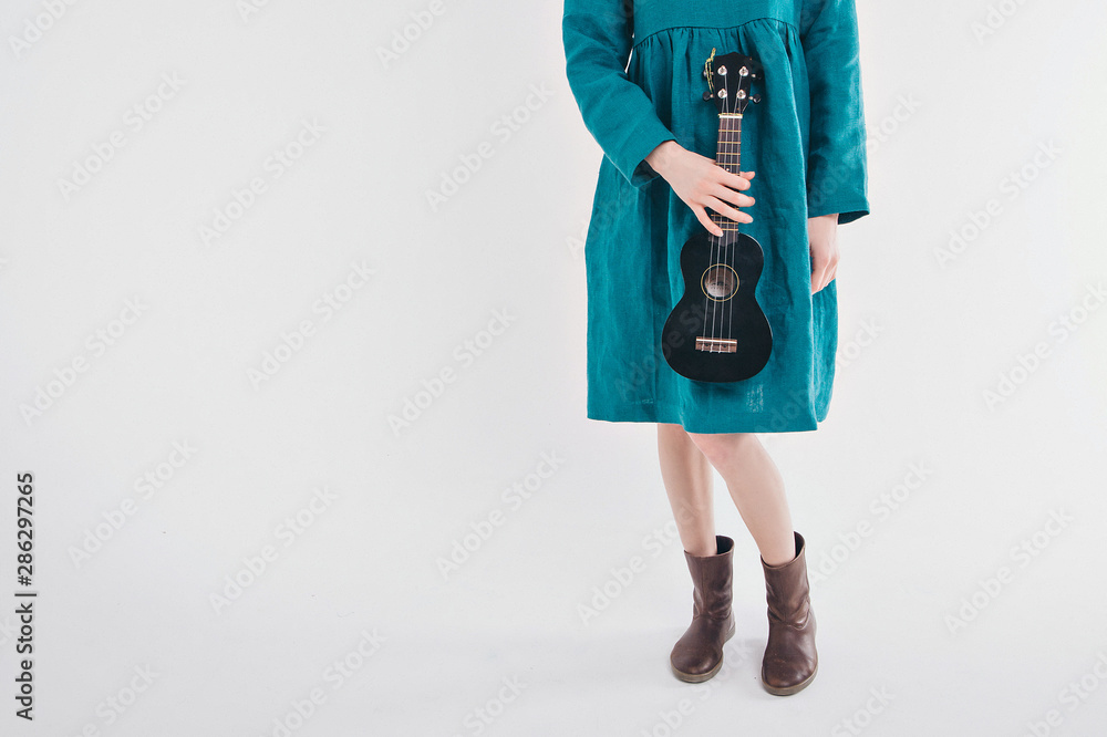 beautiful girl in blue dress with small guitar in hands on white ...