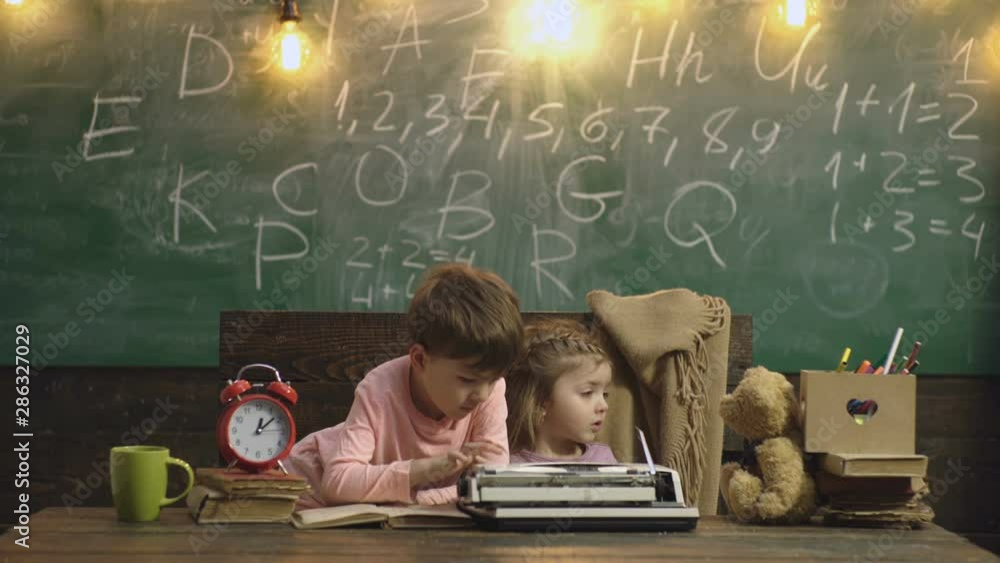 Video Stock Preschool boy and girl learning to type on typewriter in ...