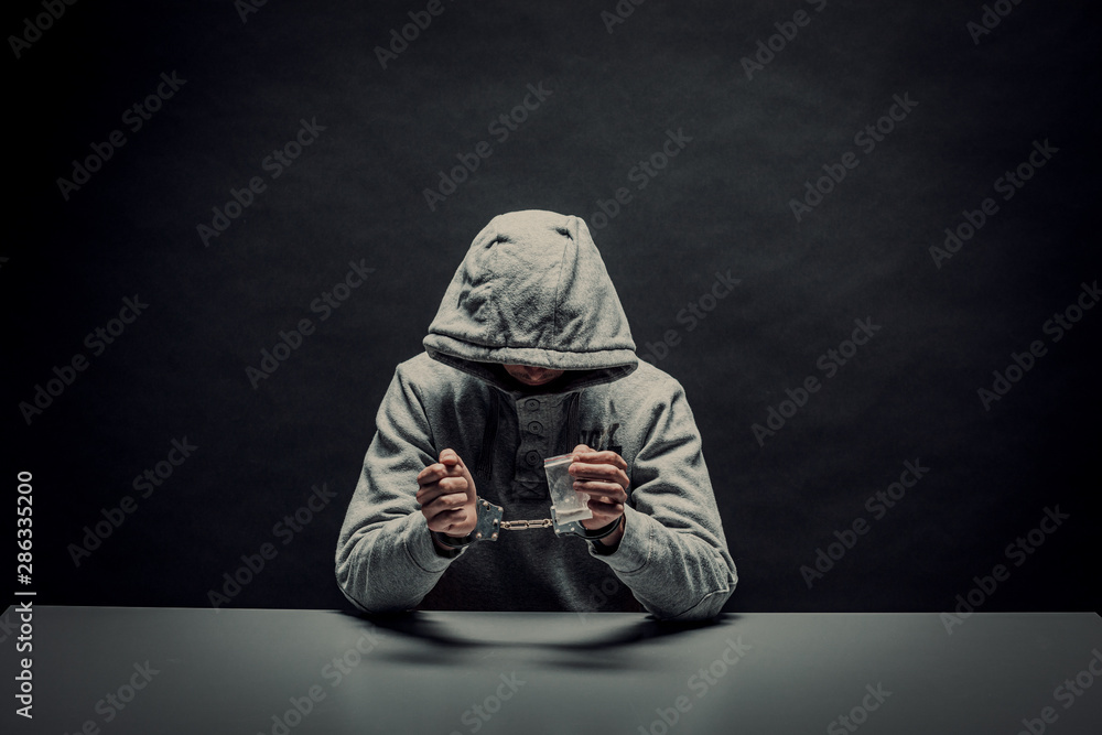 Men hands the drug dealer restrained with handcuffs. Addiction. The ...