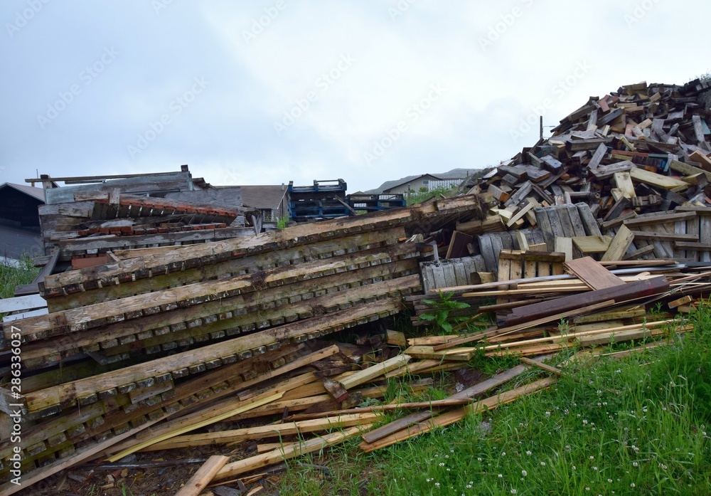 pile of demolition wood rubbish and reclaimed wood in the outdoors ...