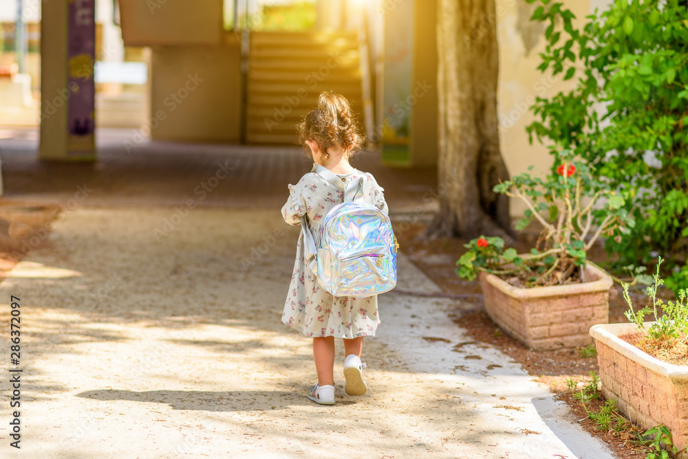 Happy kid back to school. Little girl with backpack go to elementary ...