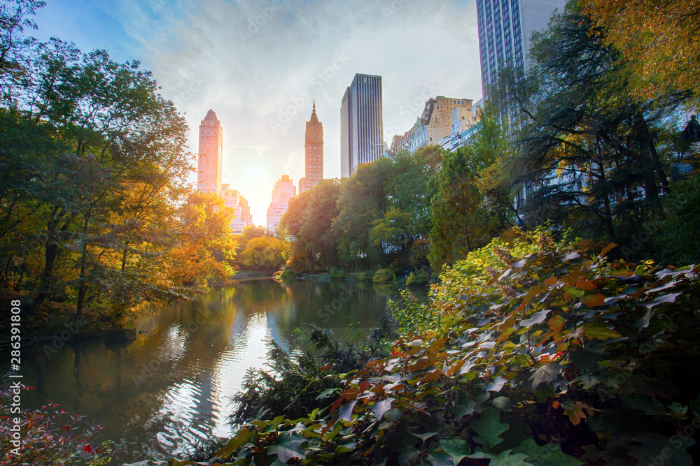New York City Manhattan, skyscrapers and colorful trees with reflection ...