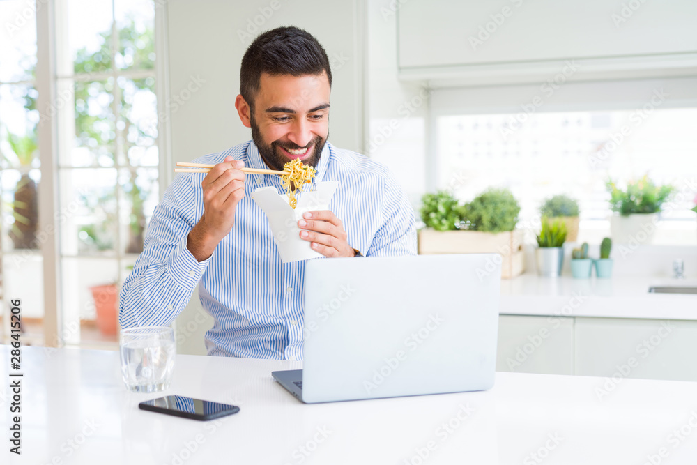 Business man eating asian food from delivery while working using ...