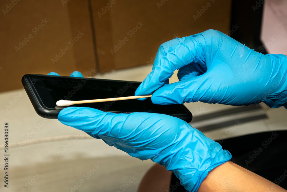 Hand holding cotton swab stick and swab dipped in diluted rubbing ...