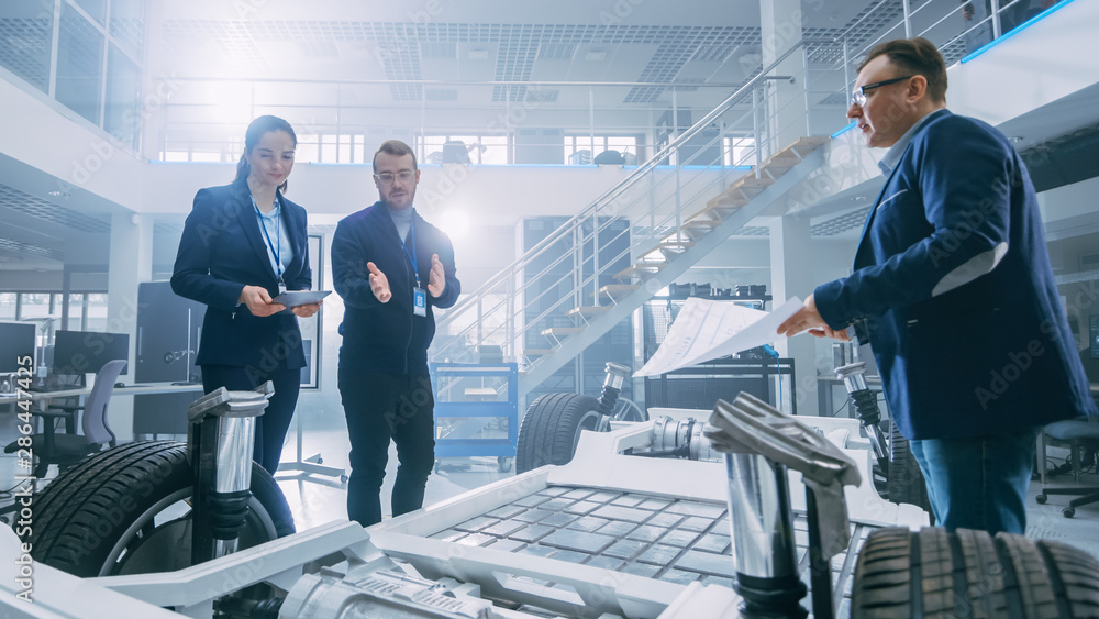 Automotive Design Engineers Talking while Working on Electric Car ...