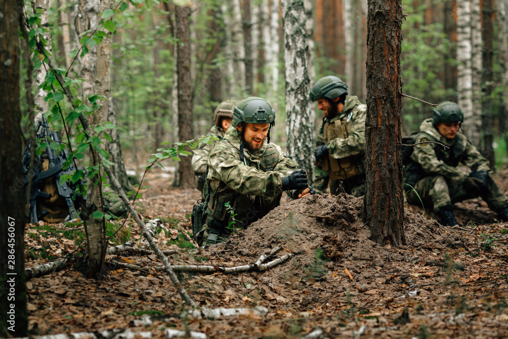 Soldiers on a halt. Preparing for the attack. Digging a trench. Stock ...