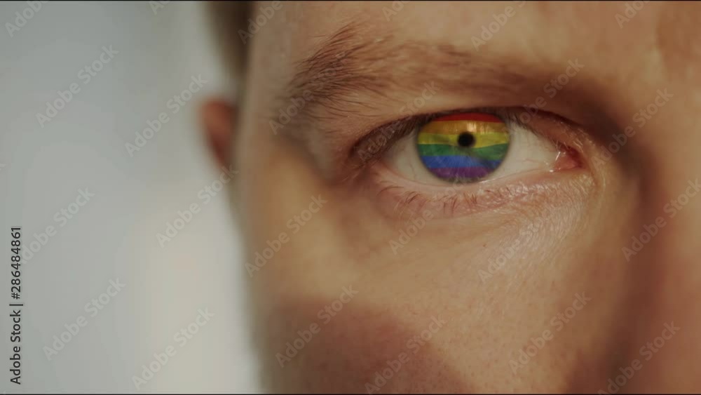 Celebrating Pride. Opening male eye close up, gay eye, LGBT eye ...