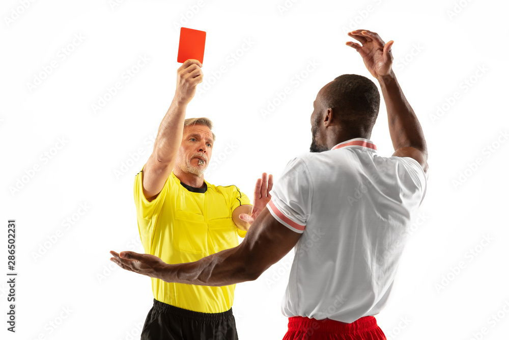 Referee showing a red card to a displeased african-american football or ...