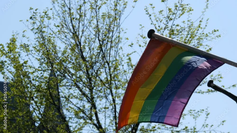 Gay pride rainbow flag LGBT flying. A multi-colored rainbow flag, a ...