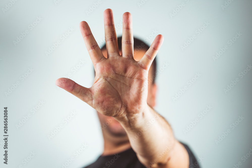 man showing hands and palm lines - Young man making stop gesture with ...
