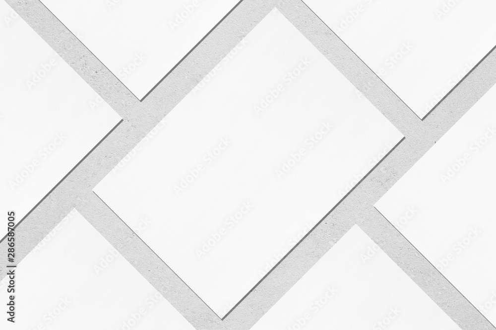 Close up of empty white rectangle poster mockups lying diagonally with ...