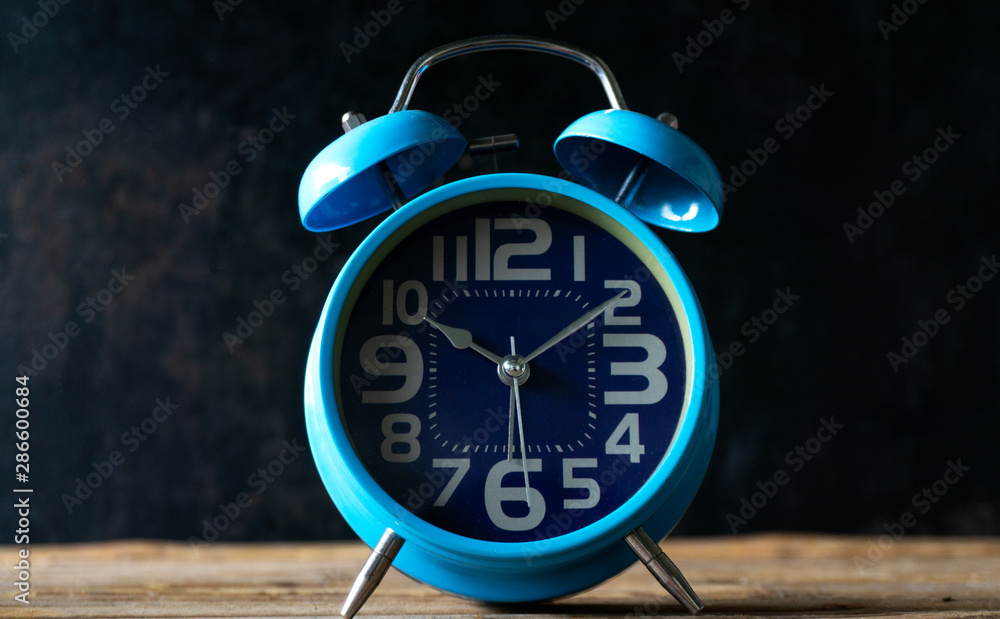 Blue Alarm clock face beginning of time 10.10 am. & pm. on black ...