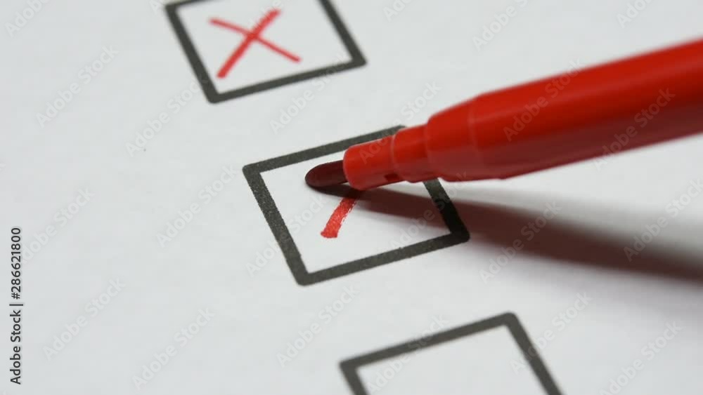 red pen make a x cross check mark sign in check box list on white paper ...
