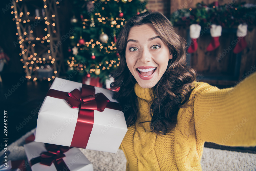 Self portrait of cheerful rejoicing girl shooting her gift box with ...