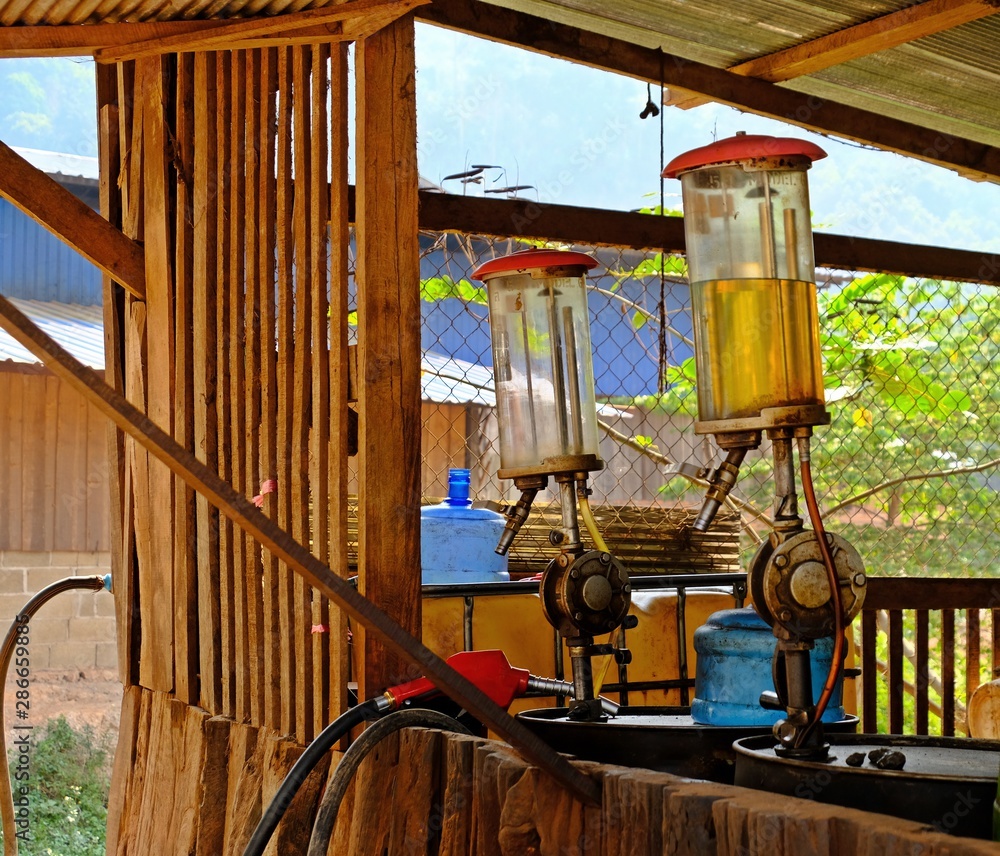 Rural and country-side gasoline station using manpower to pump fuel ...