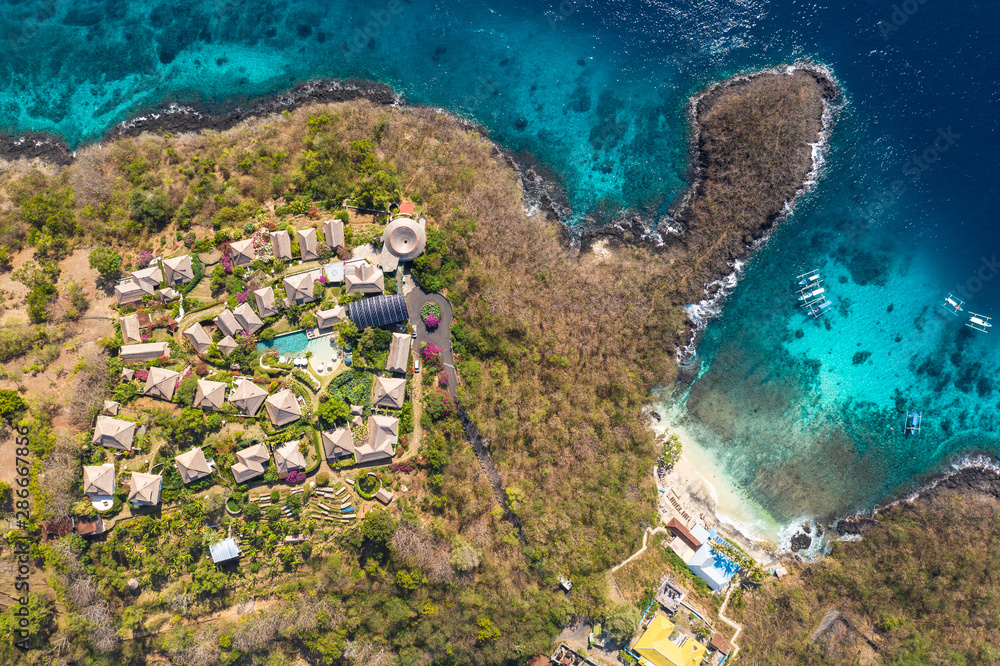 Stunning top down view of the isolated Blue Lagoon beach and a resort ...