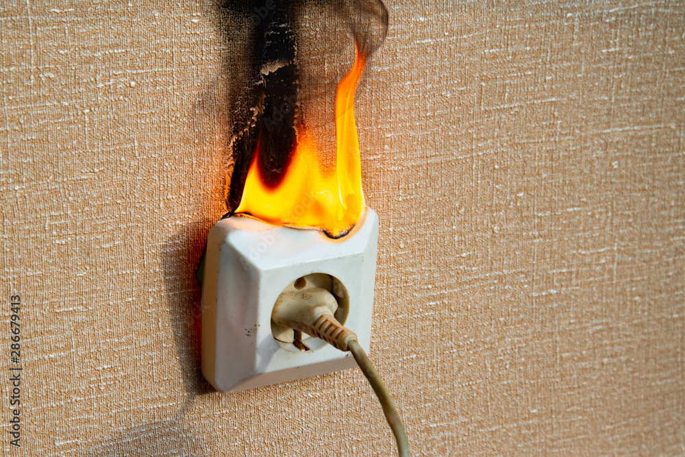 Burning electrical wiring and electrical outlet. Faulty wiring causes ...